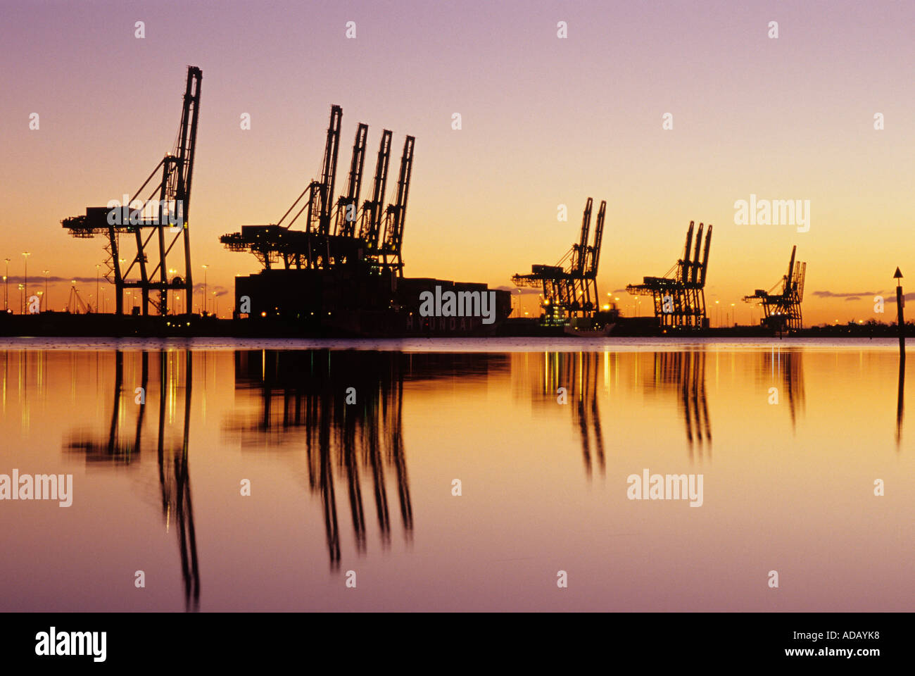 the port of southampton docks at dawn with silhouettes of large ...