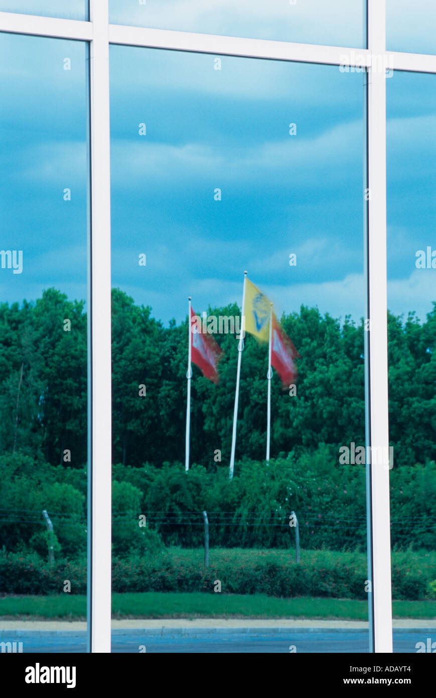 flags reflected in windows on trading estate / office buildings with ...