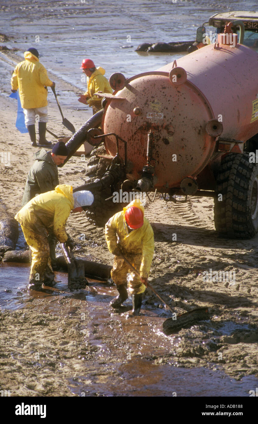 Cleaning oil from polluted beach after Sea Empress disaster ...