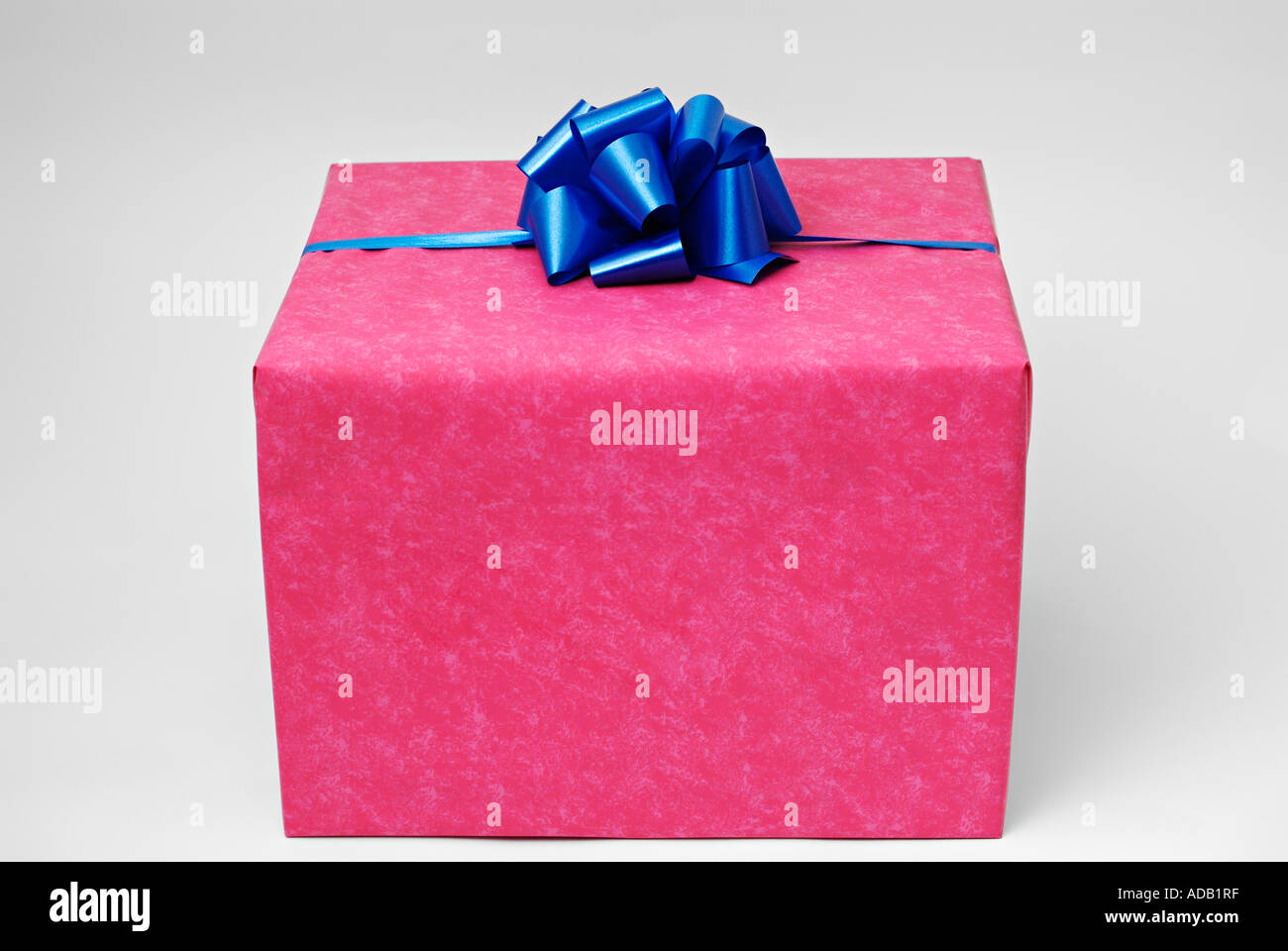 Gift Wrapped Present with Red Paper and a Blue Ribbon Stock Photo - Alamy