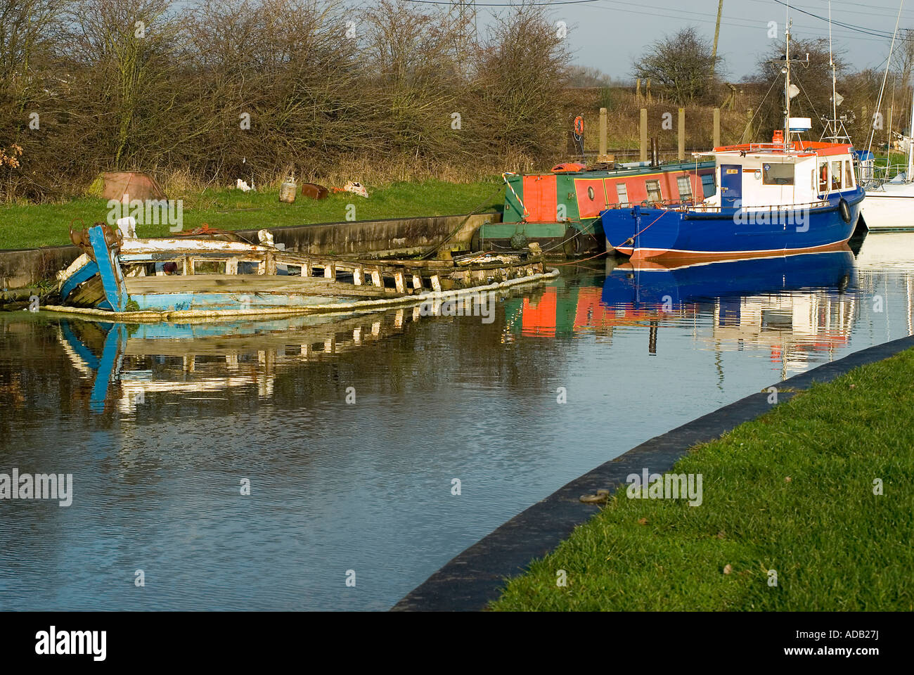 Boats on river with sinking boat Stock Photo - Alamy