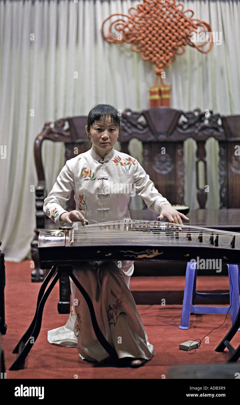 CHINA HANGZHOU A female Chinese musician plays the Chinese Zither or ...