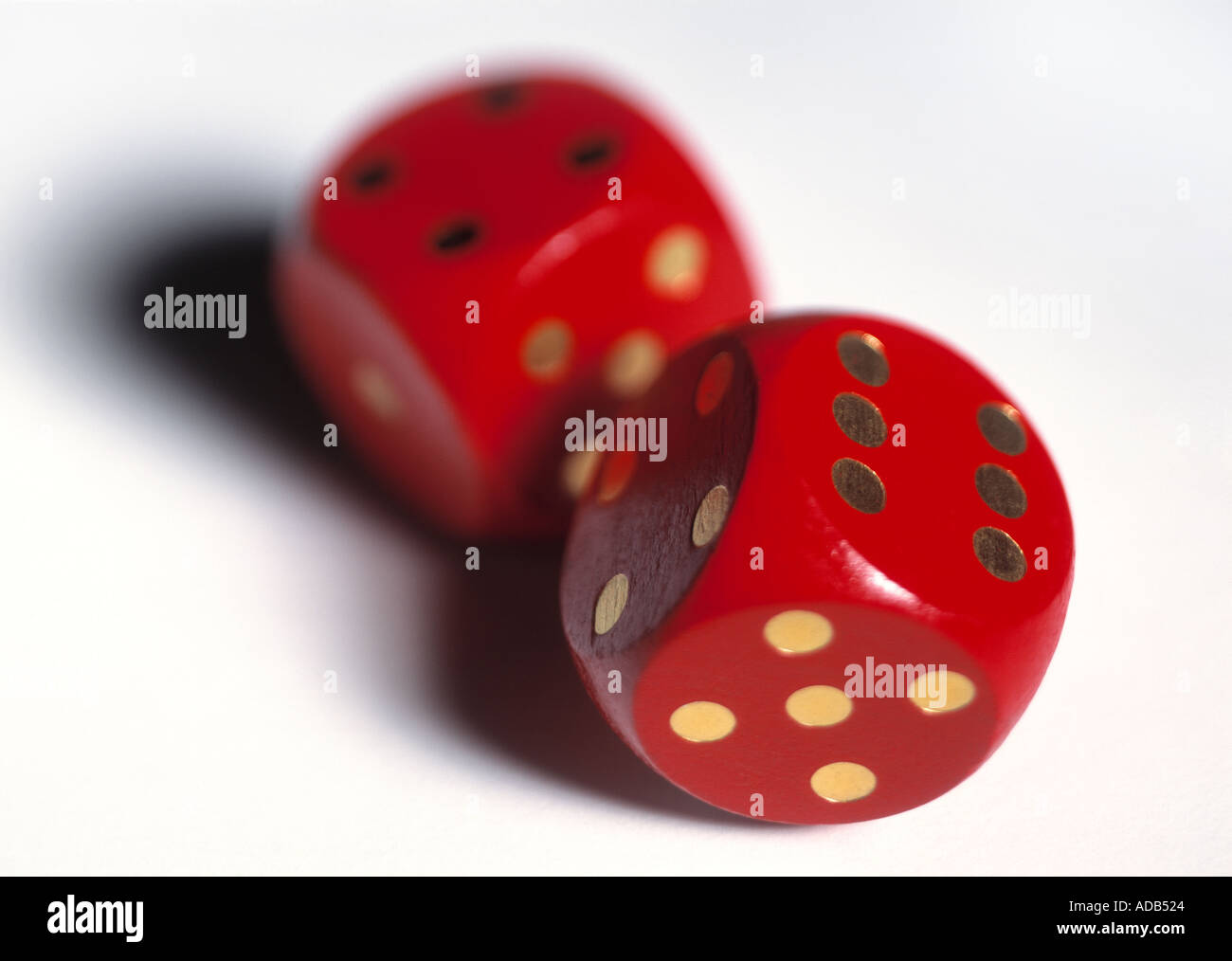 Two dice red dice with gold spots tumbling on white background Stock ...