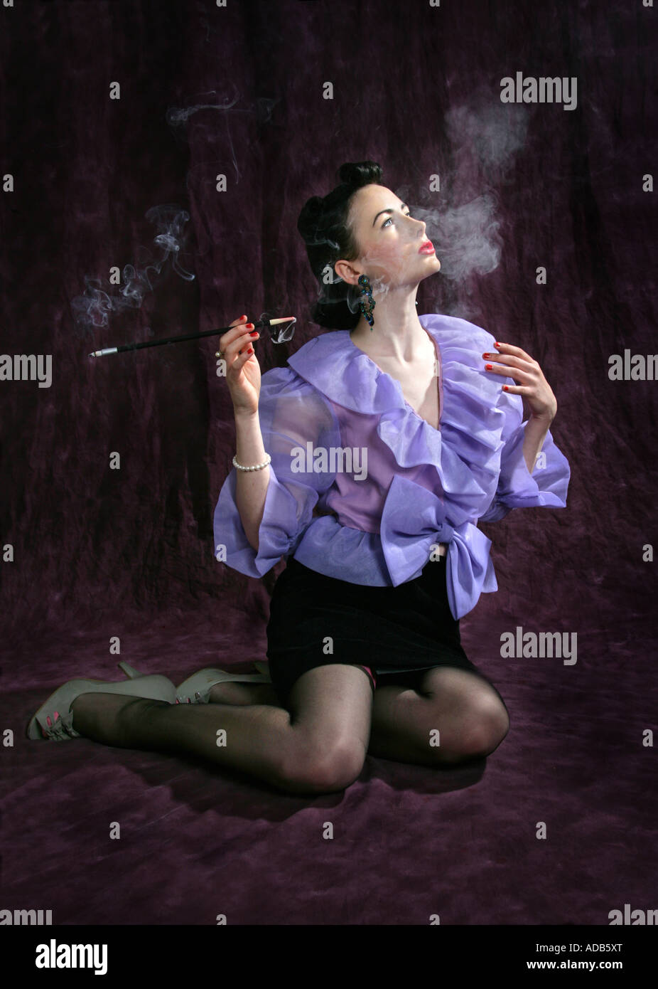 A Pin Up Girl in a Purple Blouse Holding a Cigarette Holder and Smoking ...