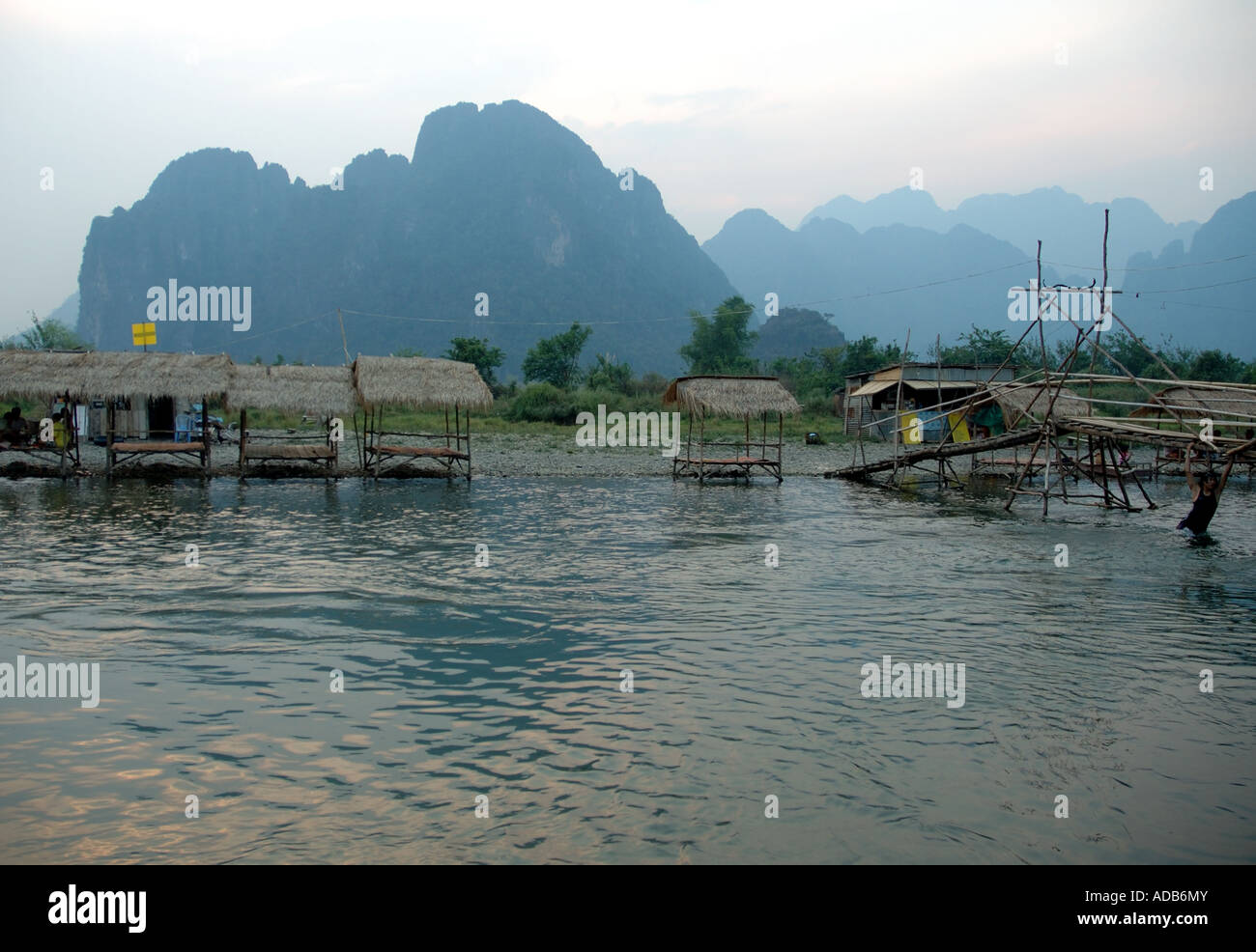 River and huts running through Vang Vieng in Laos Stock Photo - Alamy