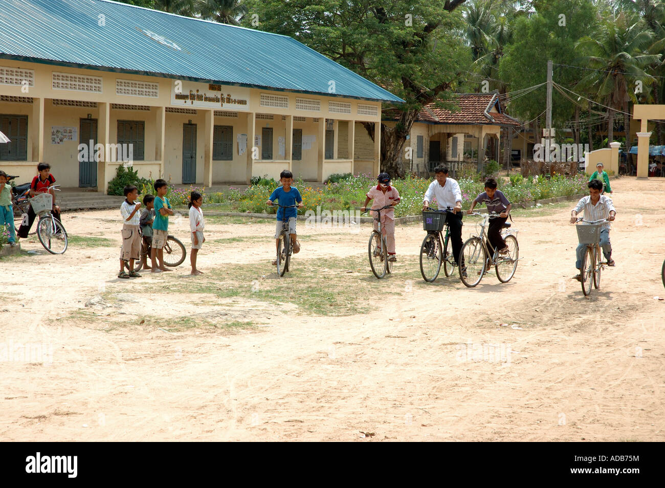 Children taking part in a slow bike race at a school in Kampot ...