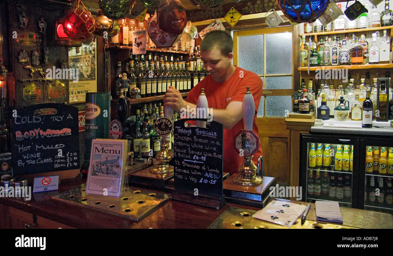 Pulling a pint of Flowers beer in the bar of The Gun Inn Keyhaven ...