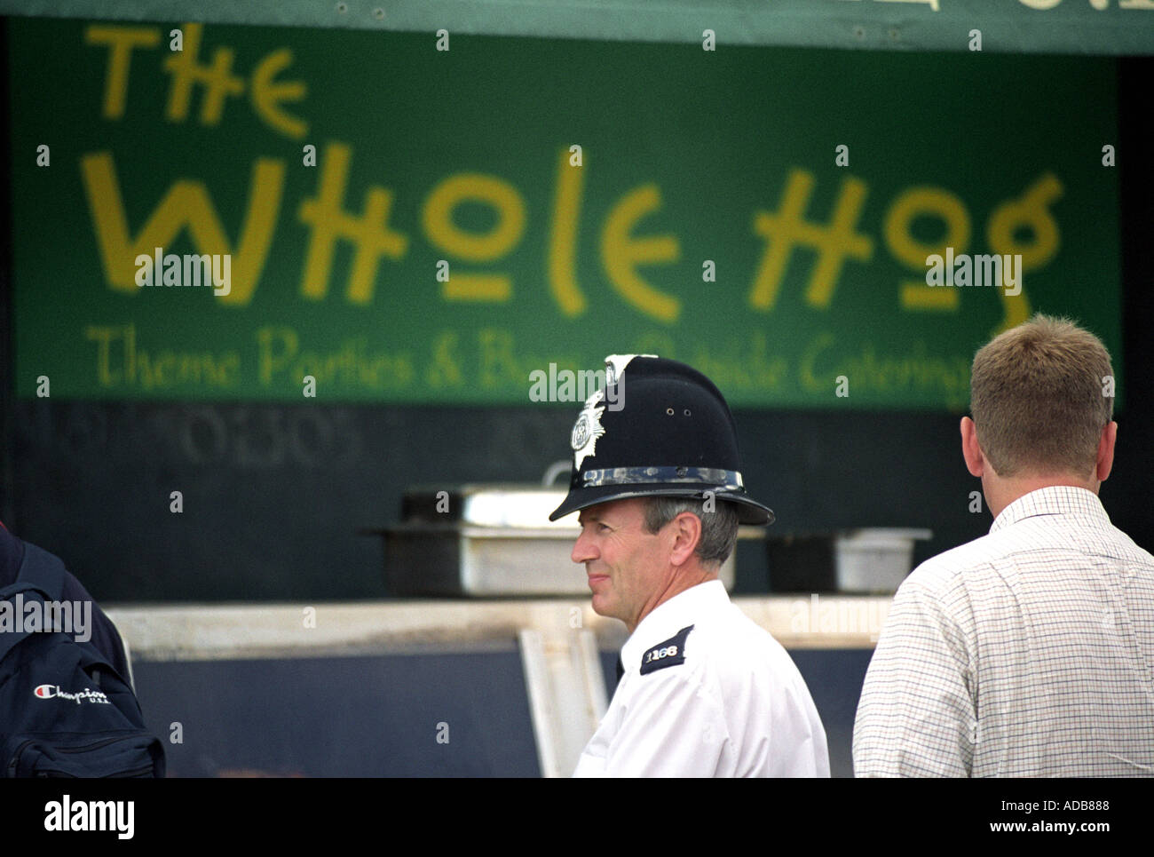 Policeman in front of a The Whole Hog sign Stock Photo - Alamy