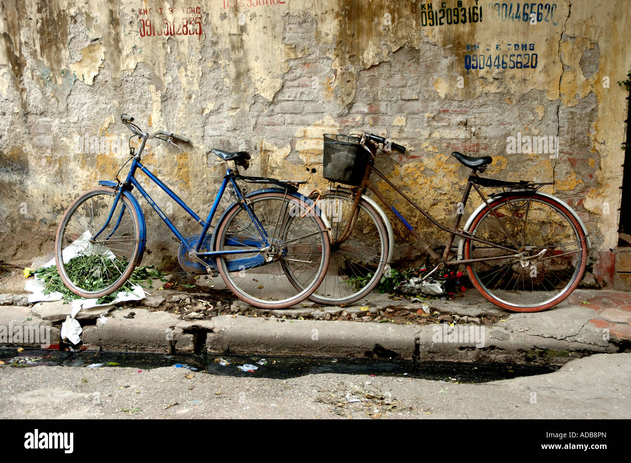 Bikes leaning against a wall in the busy City of Hanoi in Northern ...