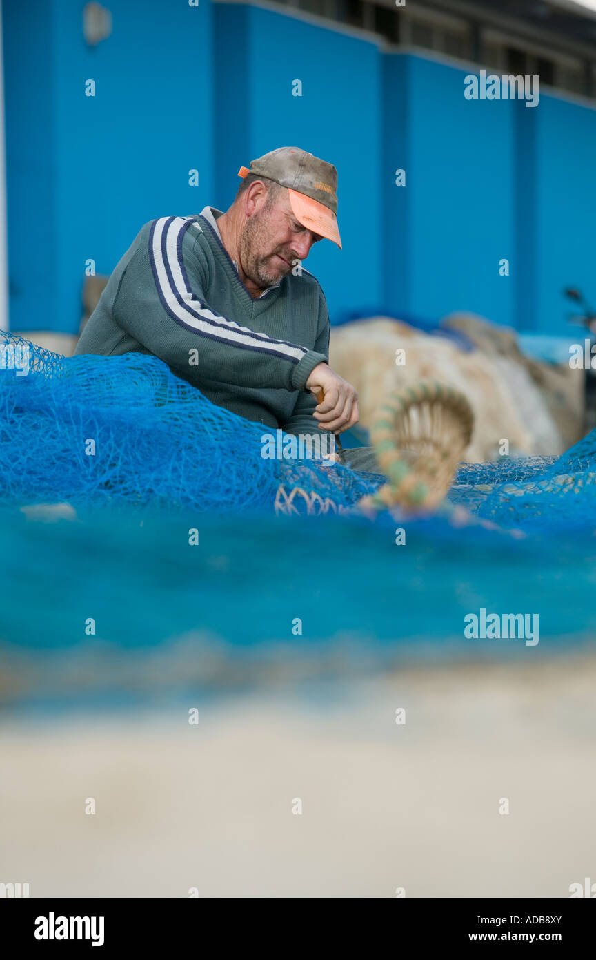 Commercial fisherman mending nets hi-res stock photography and images ...