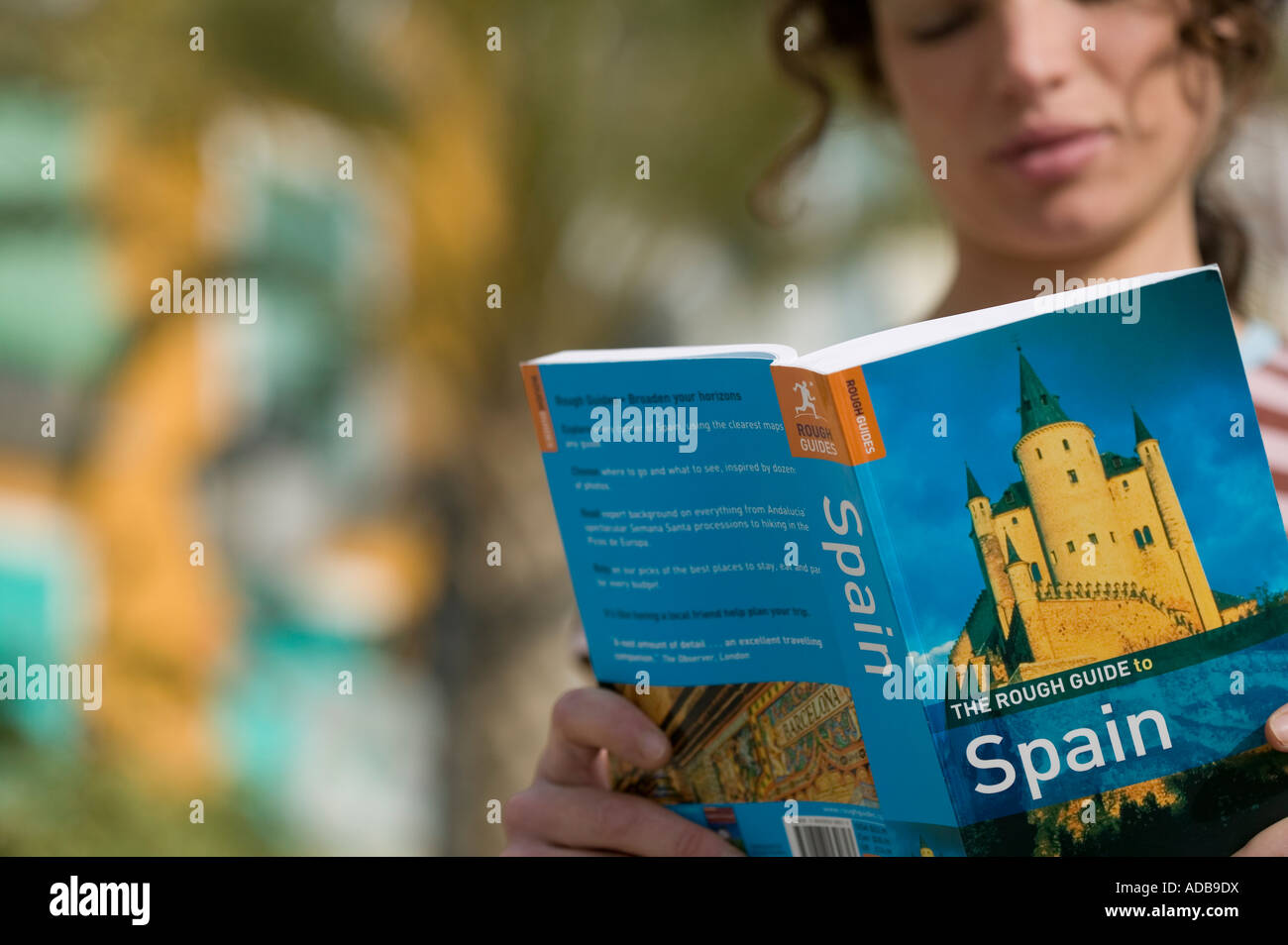 Female tourist reading Spanish guidebook Stock Photo - Alamy