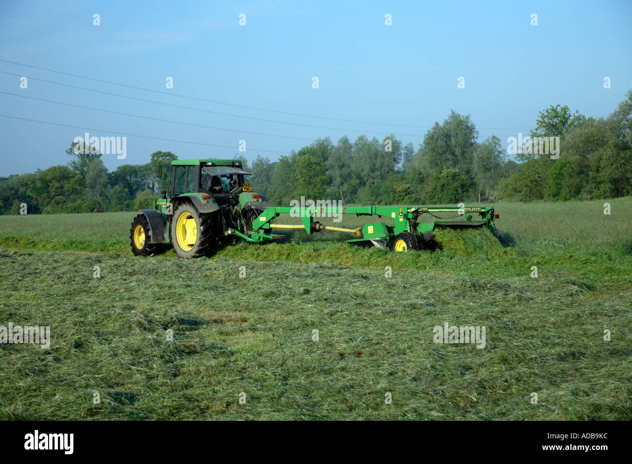 Tractor mowing grass for hay 6 Stock Photo - Alamy