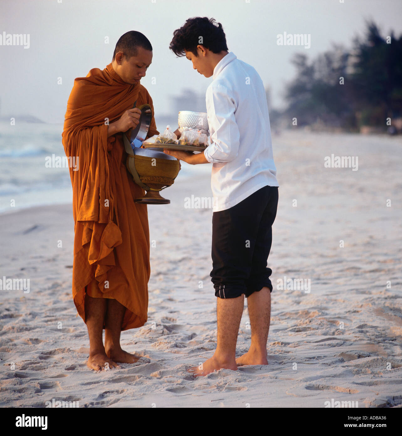 Buddhist monk holding collecting bowl receiving food donation from a ...