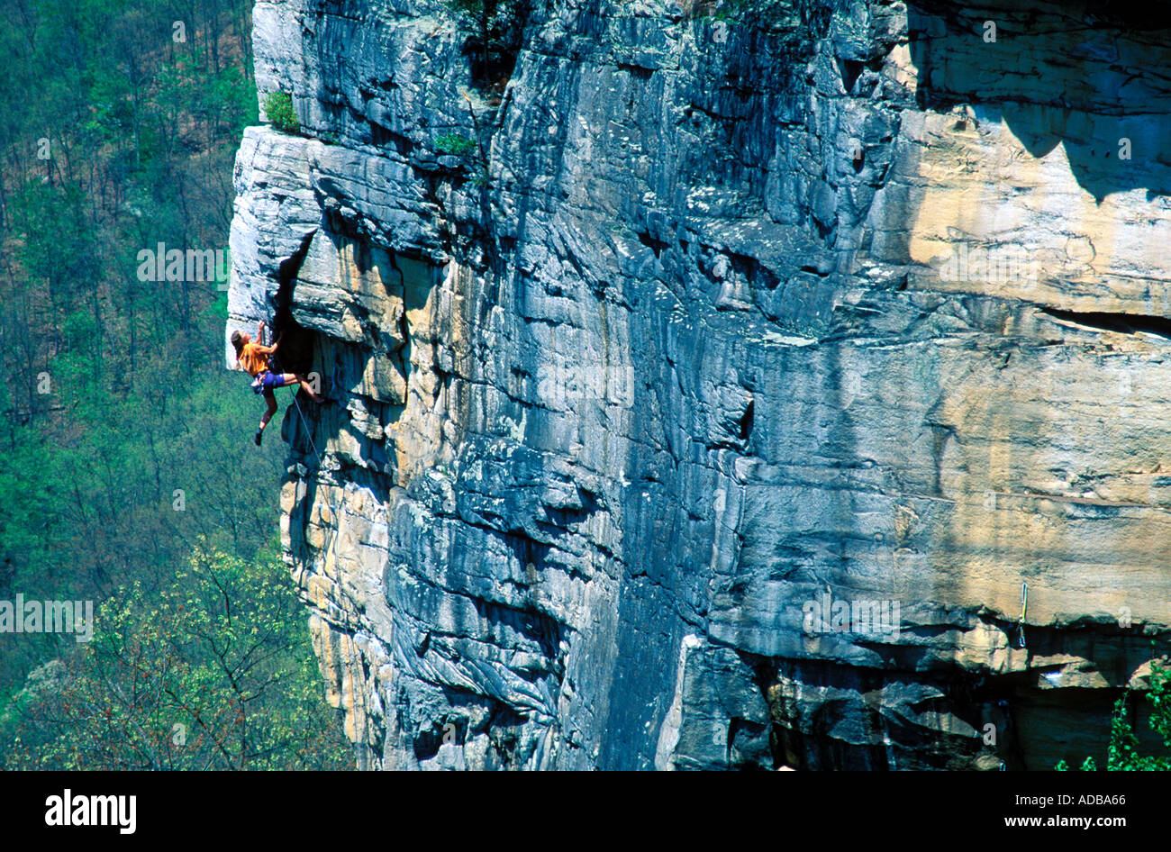 Female rock climber on sheer rock face Stock Photo - Alamy