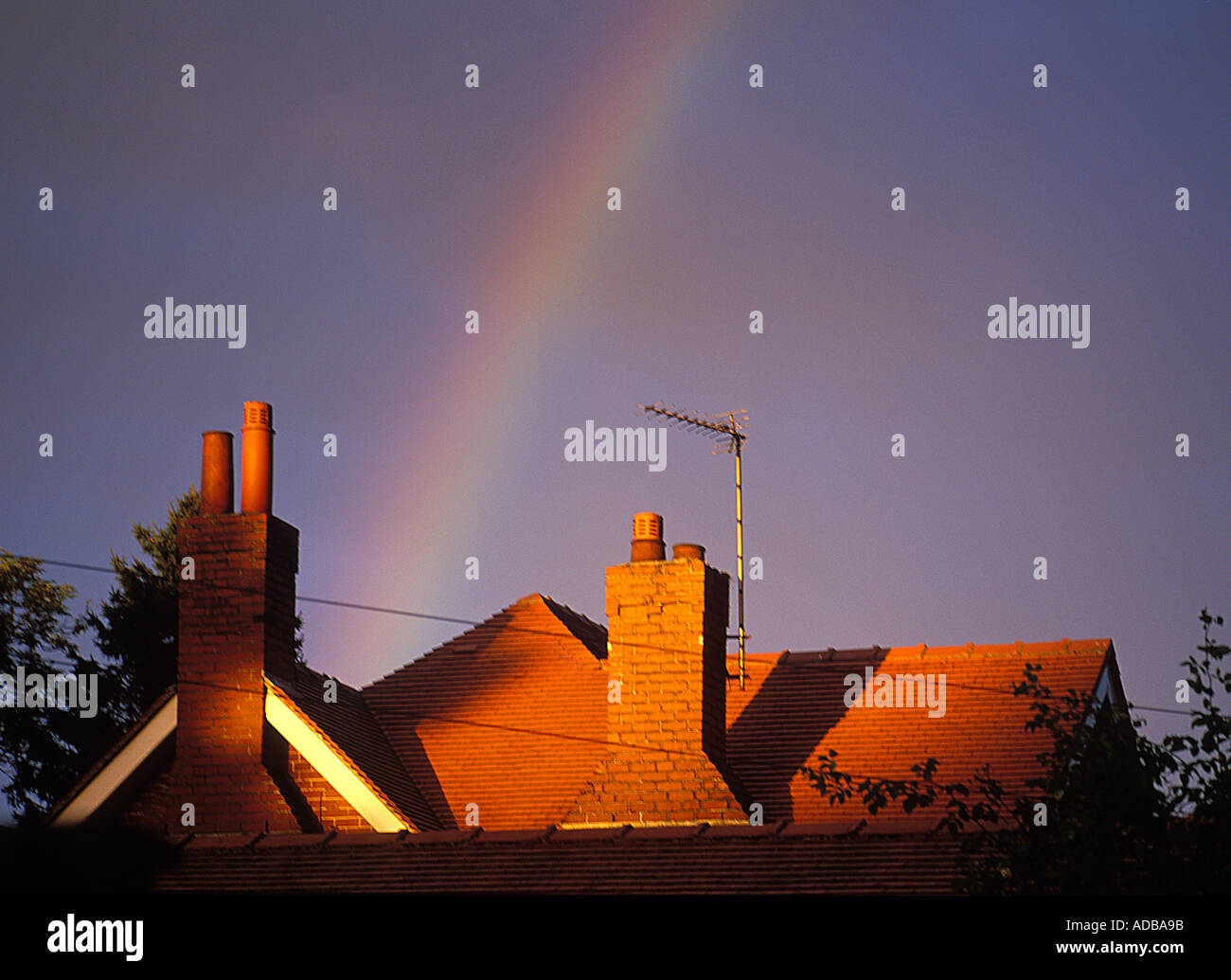 Suburban roof top crowned with a rainbow Stock Photo - Alamy