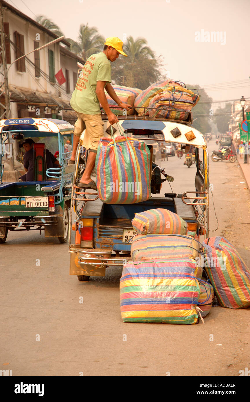 Man unloading van in preperation for the night market in Luang Prabang ...