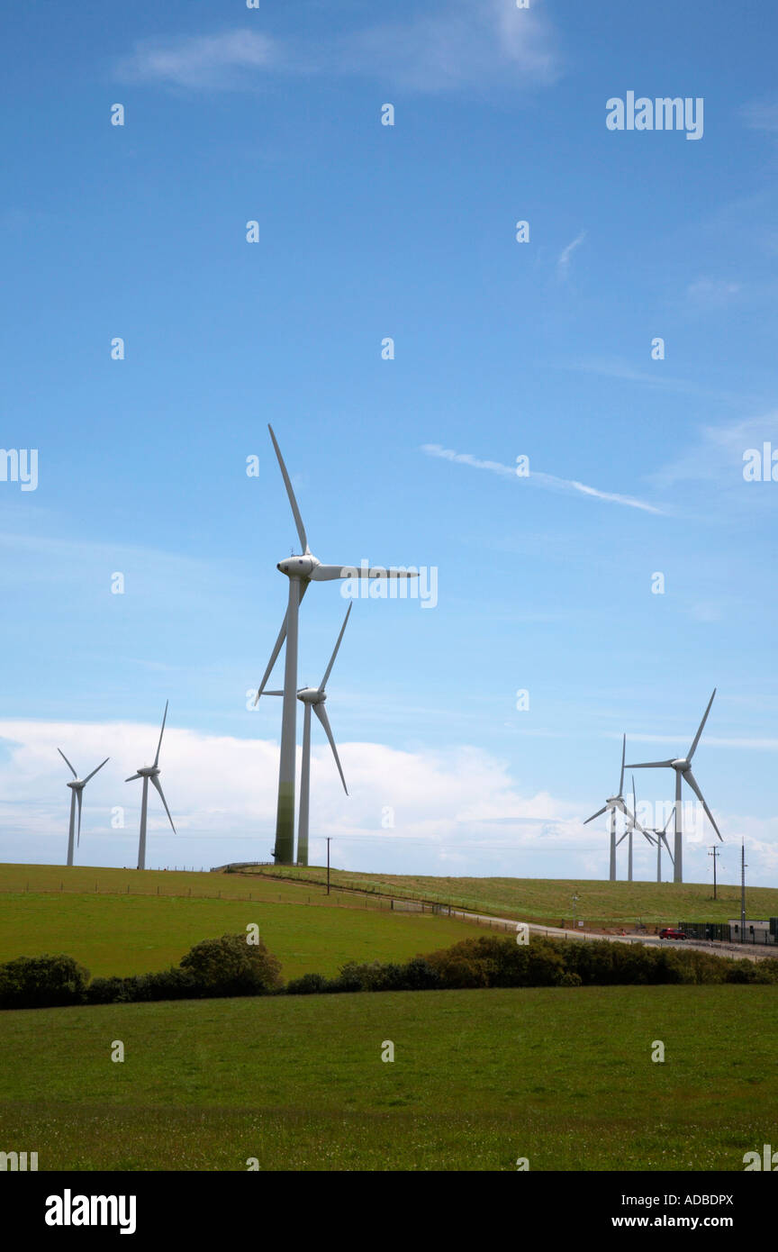 8 wind turbines and electricity sub station on wind farm against blue ...