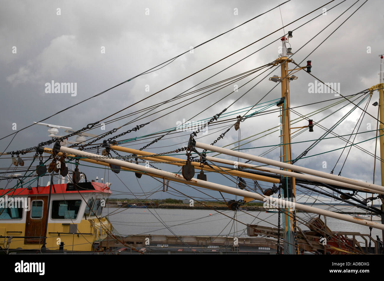 rigging and booms of fishing boats moored in wexford town harbour with ...