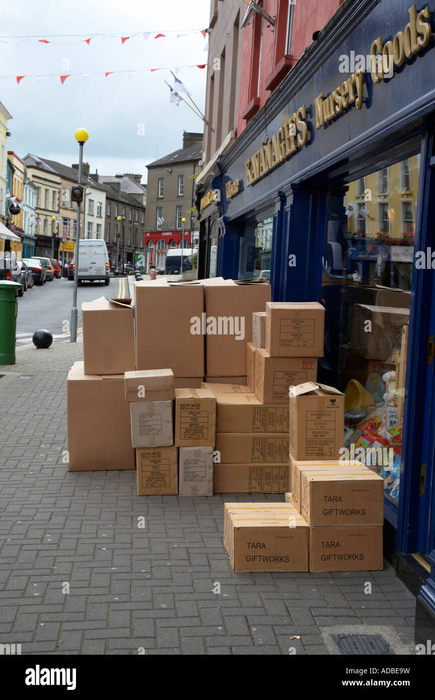pile of cardboard boxes with deliveries piled up outside gift shop in ...