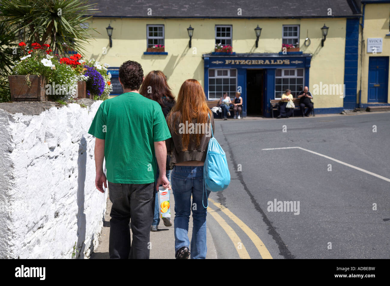 tourists walk towards fitzgeralds pub in the village of avoca from the ...