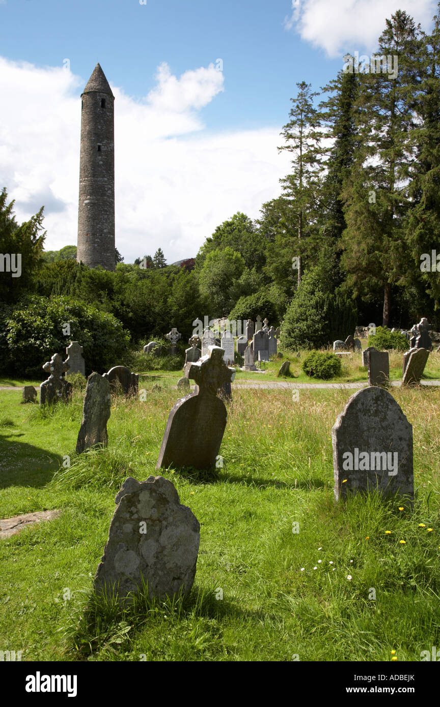 St Kevins Round Tower and graveyard at Glendalough monastic site county ...