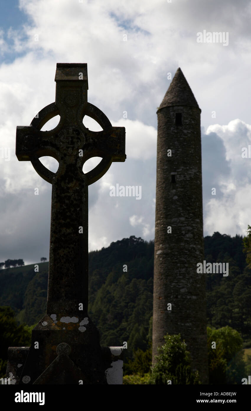 St Kevins Round Tower and celtic cross headstone in graveyard at ...