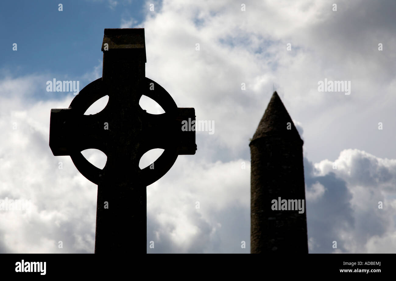 top of St Kevins Round Tower and celtic cross headstone at Glendalough ...