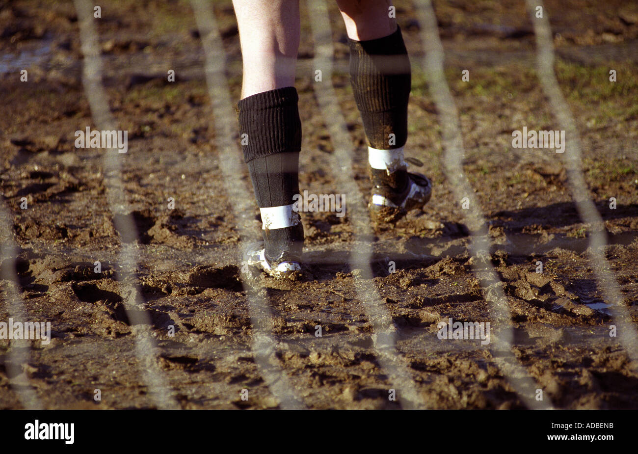 Stowmarket Town goalkeeper standing in a muddy goal mouth during a game ...