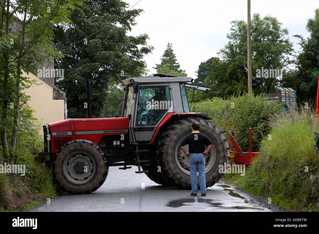 massey ferguson red tractor 3690 with farm hand helper blocking country ...