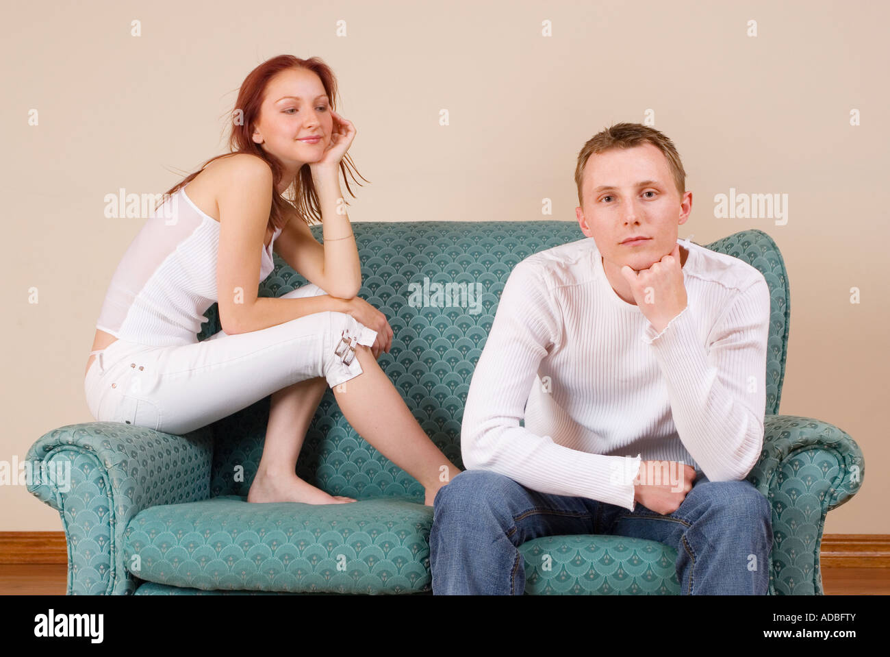 Woman and boyfriend sitting on couch Stock Photo - Alamy