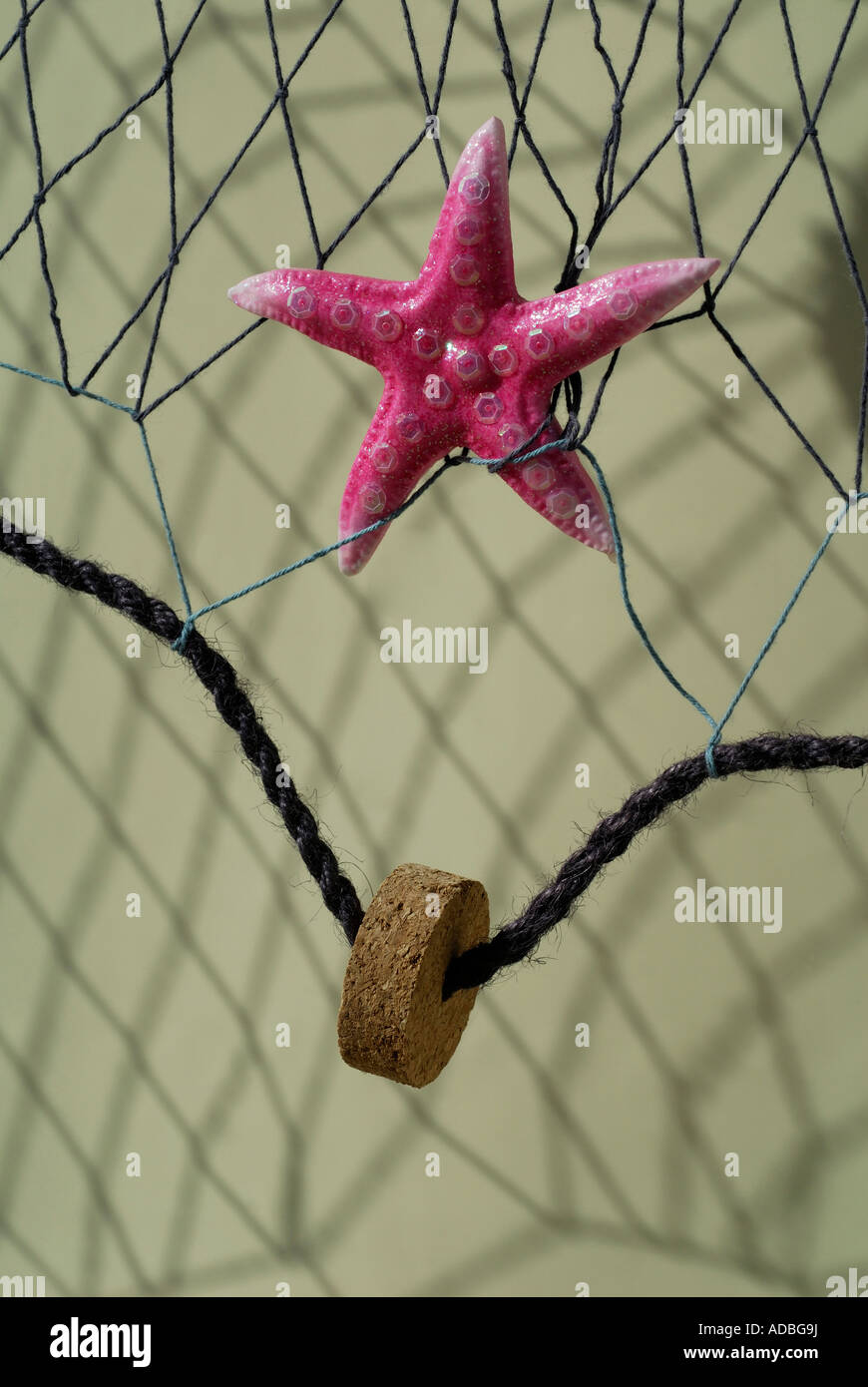 Plastic starfish and fishing net decoration, France Stock Photo - Alamy