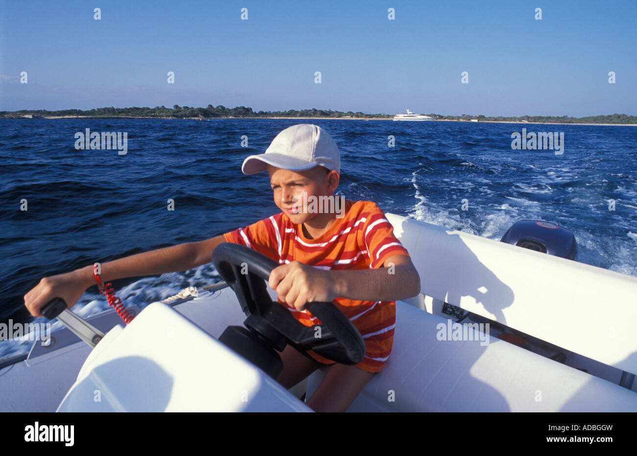 Boy cruising a motor boat Majorca Balearic Islands Spain Stock Photo ...