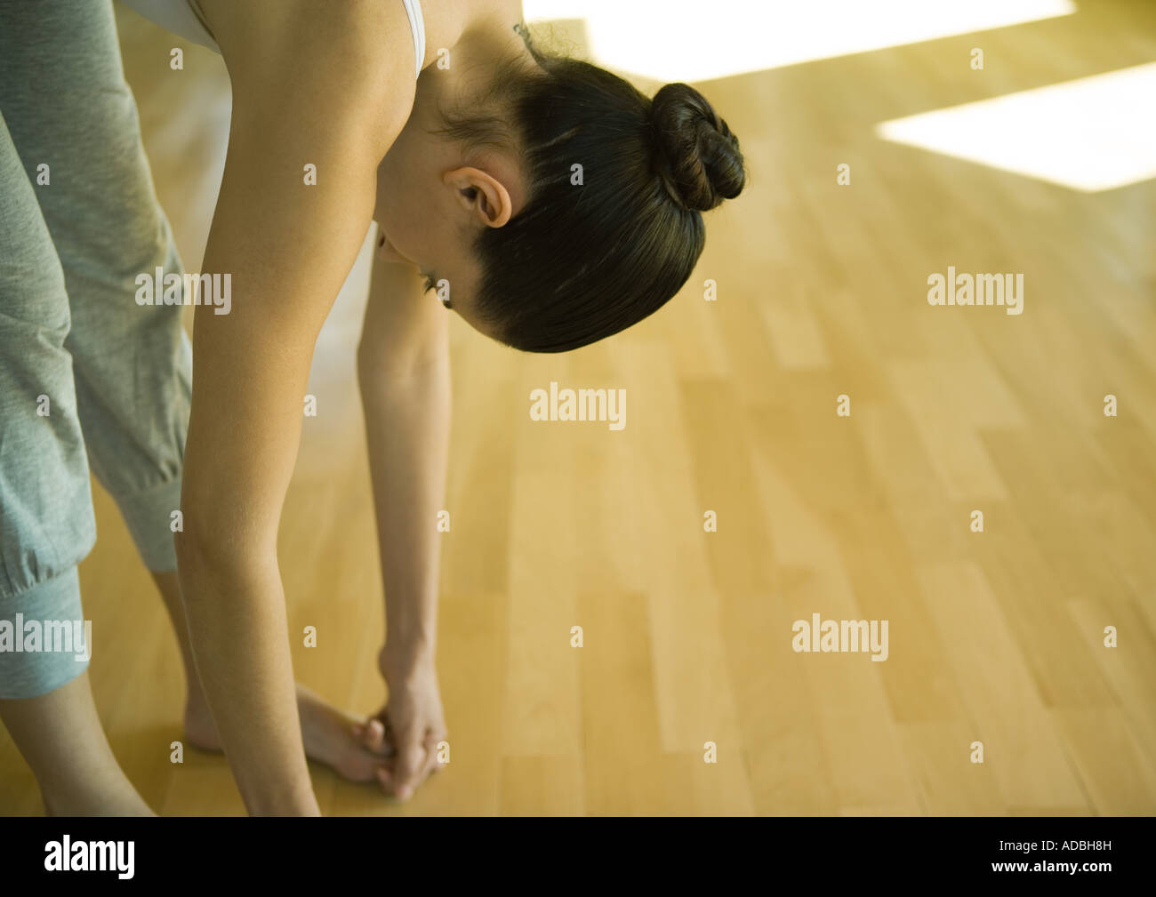 Woman bending over touching toes hi-res stock photography and images ...