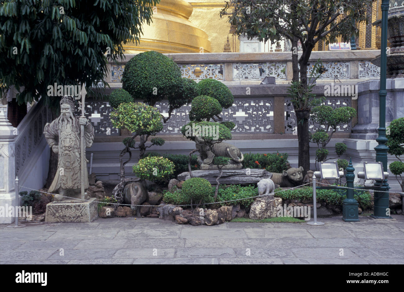 Statue and mini trees at base of Phra Sri Rattana Chedi, Grand Palace ...