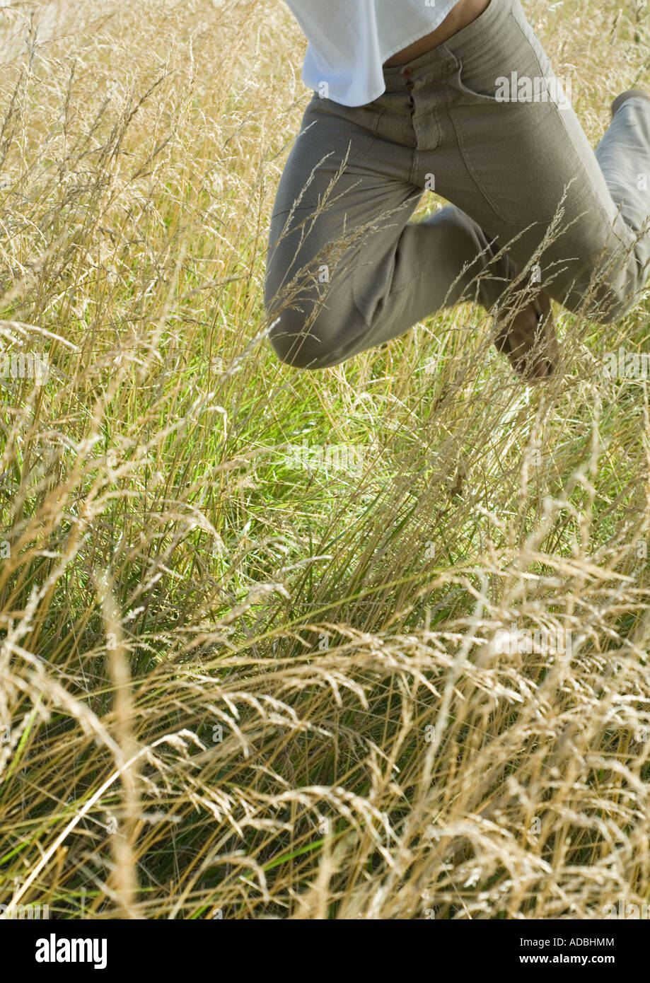 Man jumping in field, waist down Stock Photo - Alamy