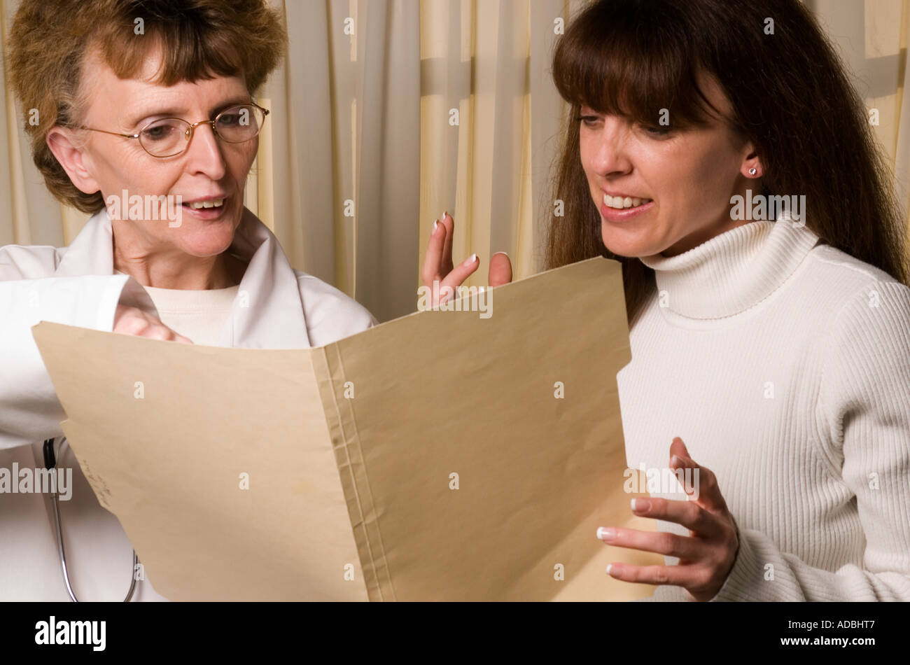 Woman Doctor Shows Medical Chart to Caucasian Female Patient (30-35 ...