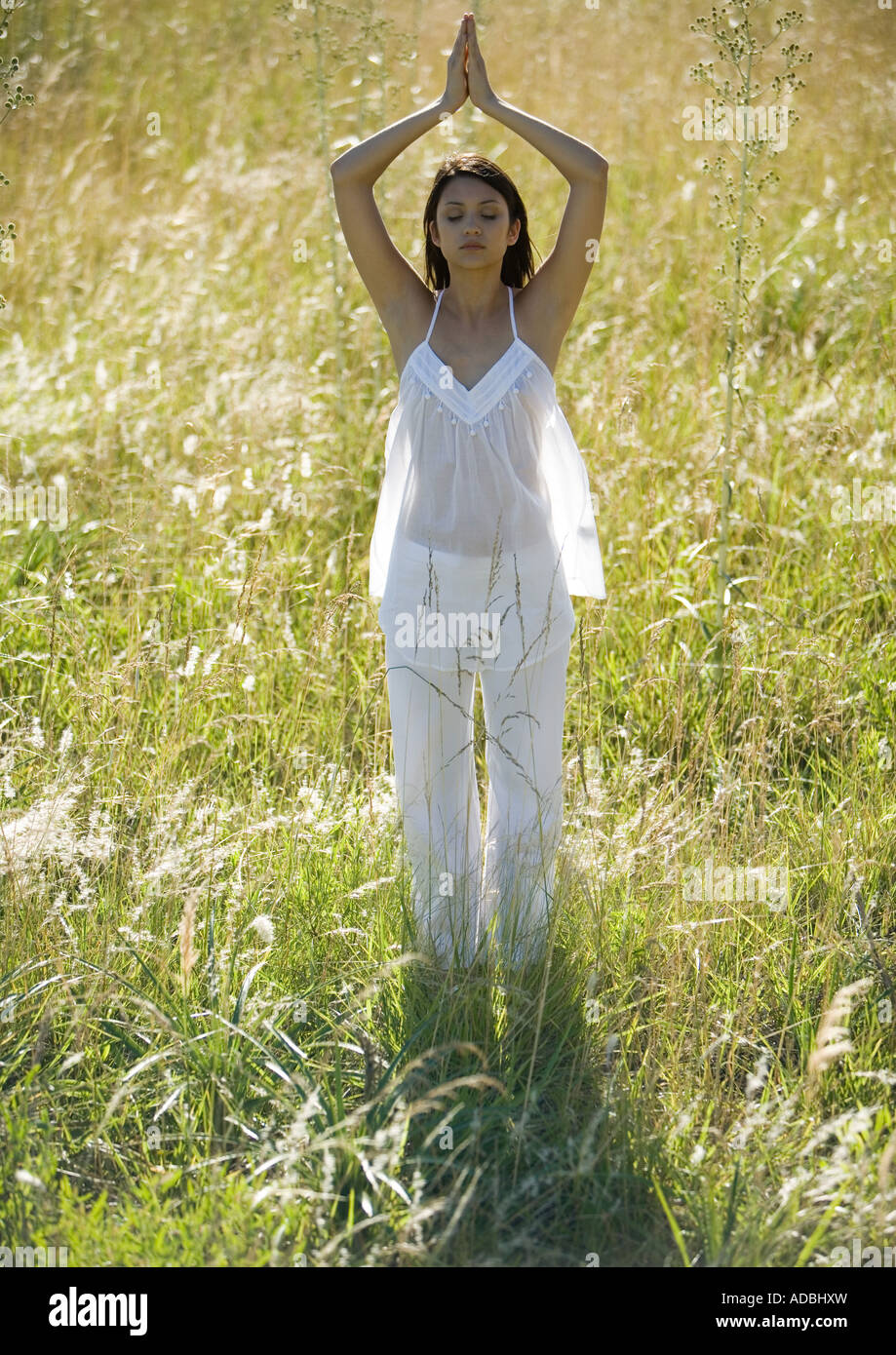 Woman doing yoga pose in field Stock Photo - Alamy