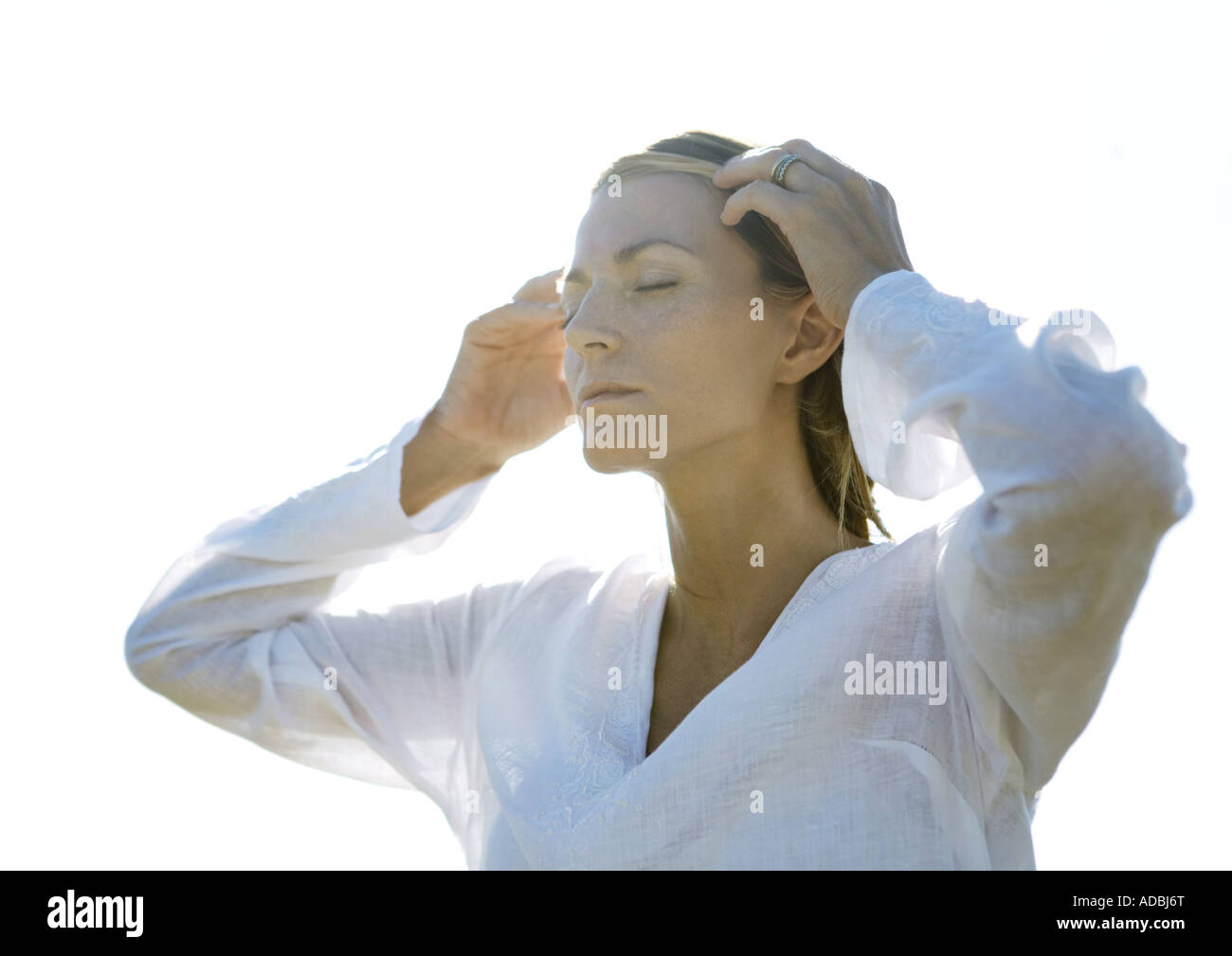 Woman pushing hair back outdoors hi-res stock photography and images ...