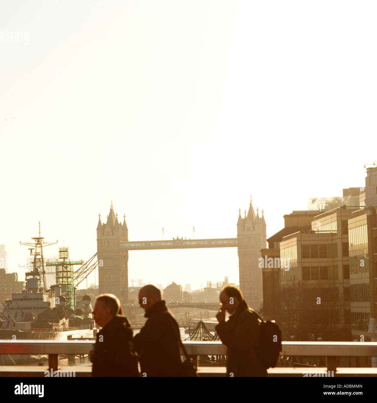 Going to work early morning office workers walking over London Bridge ...