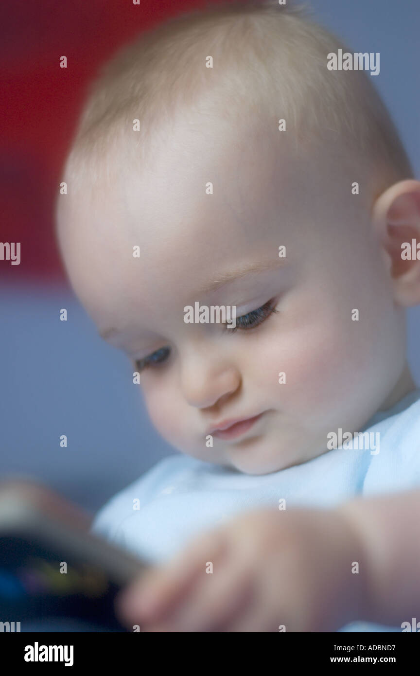 10 month old baby boy reading a book Stock Photo - Alamy