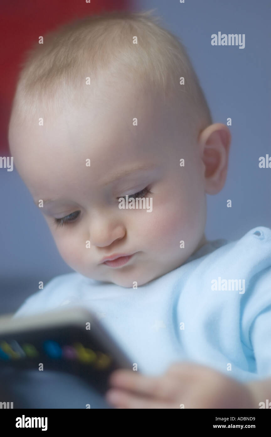 Baby boy reading a book Stock Photo - Alamy