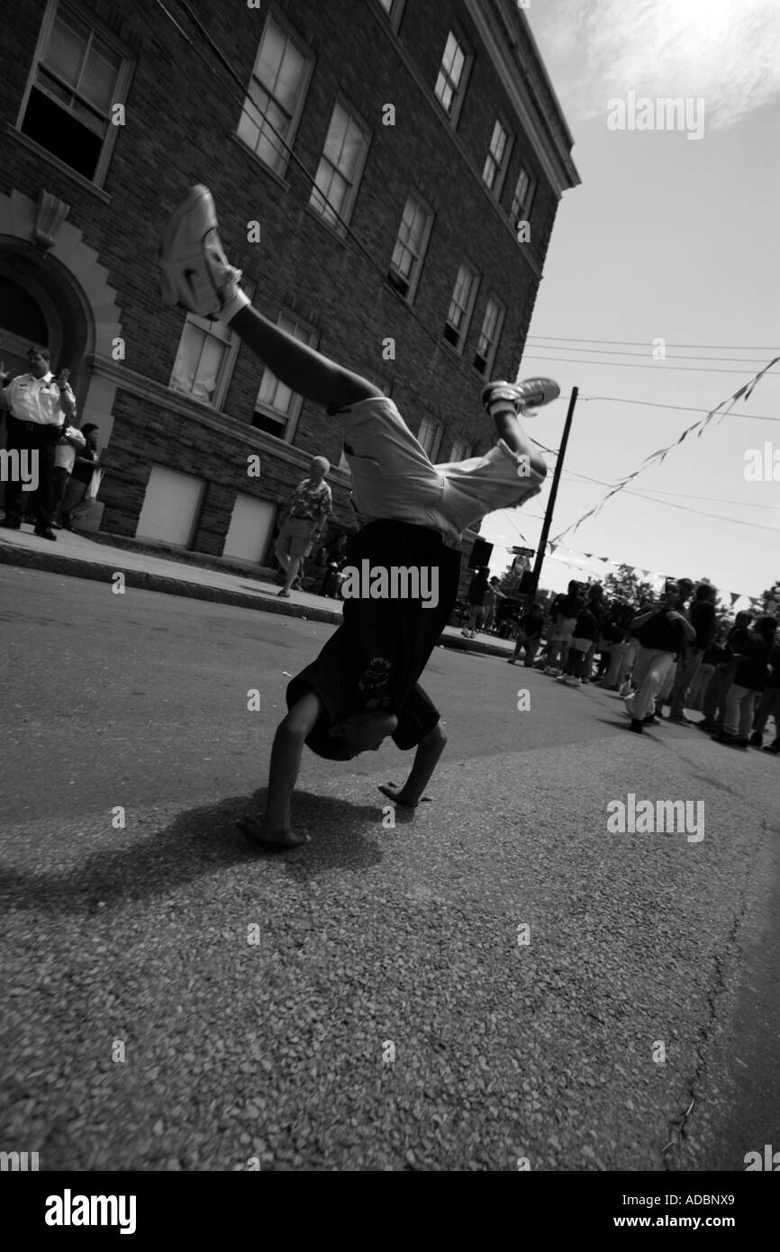 Child doing a handstand cartwheel in the street celebrations Stock ...