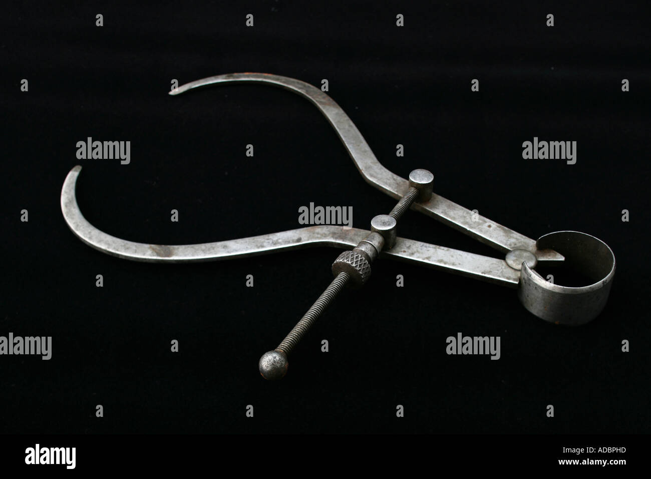 An antique caliper measurement tool on a black background Stock Photo ...