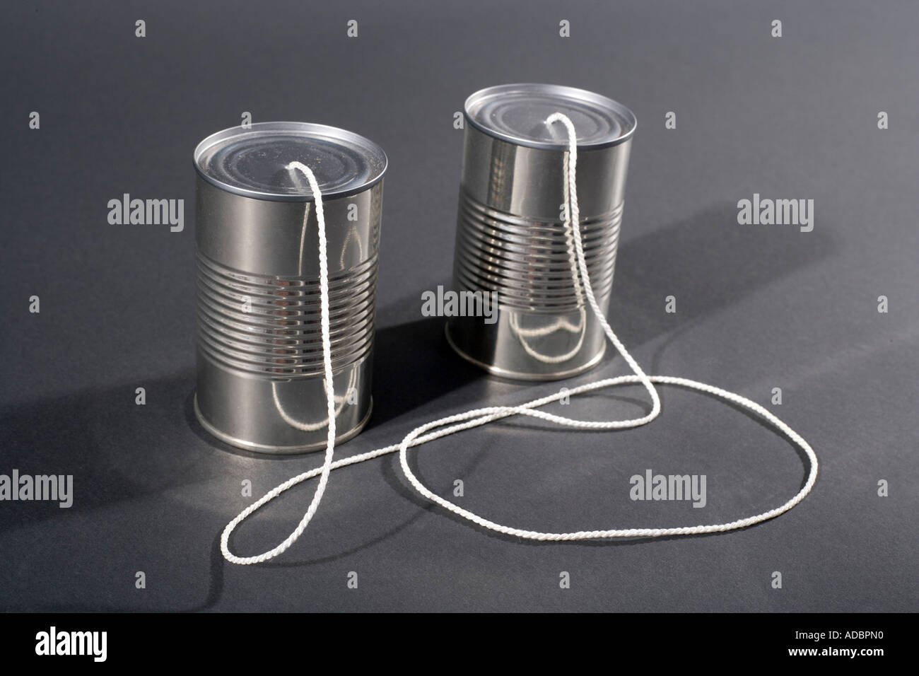 Two cans with string form a simple child's communication device A ...