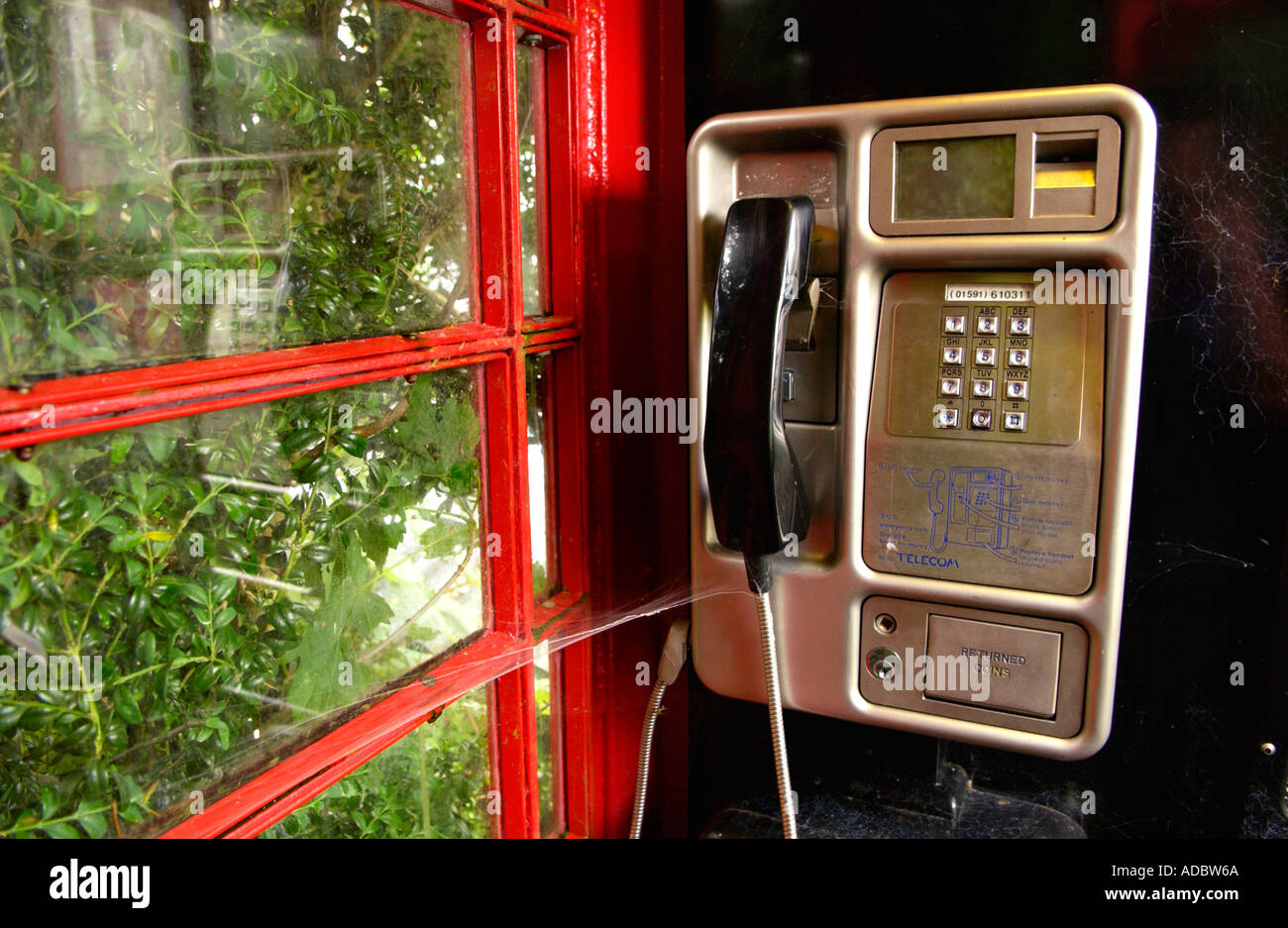 Overgrown and little used red BT phone box at Cefngorwydd near ...