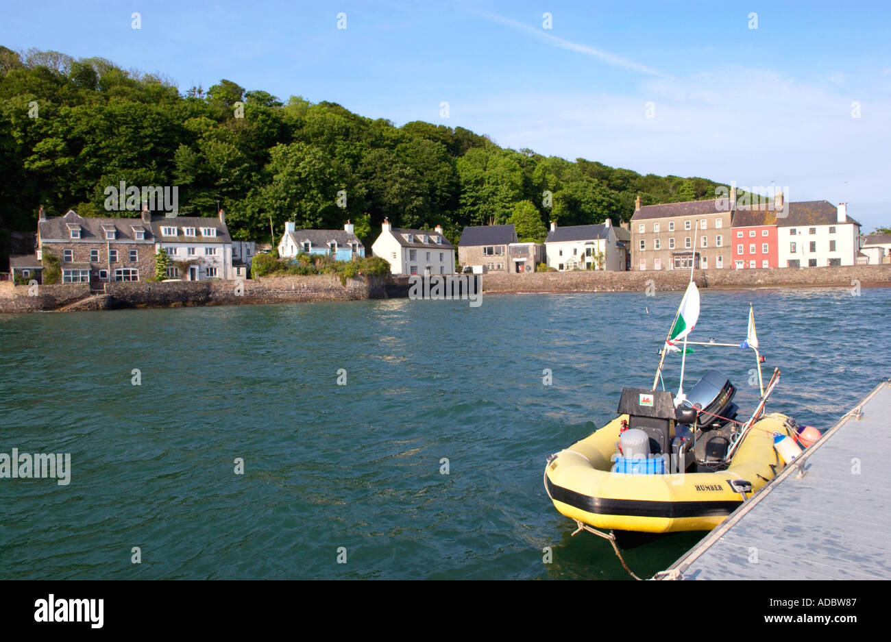 Waterfront period houses next to the sea and boat mooring boardwalk at ...