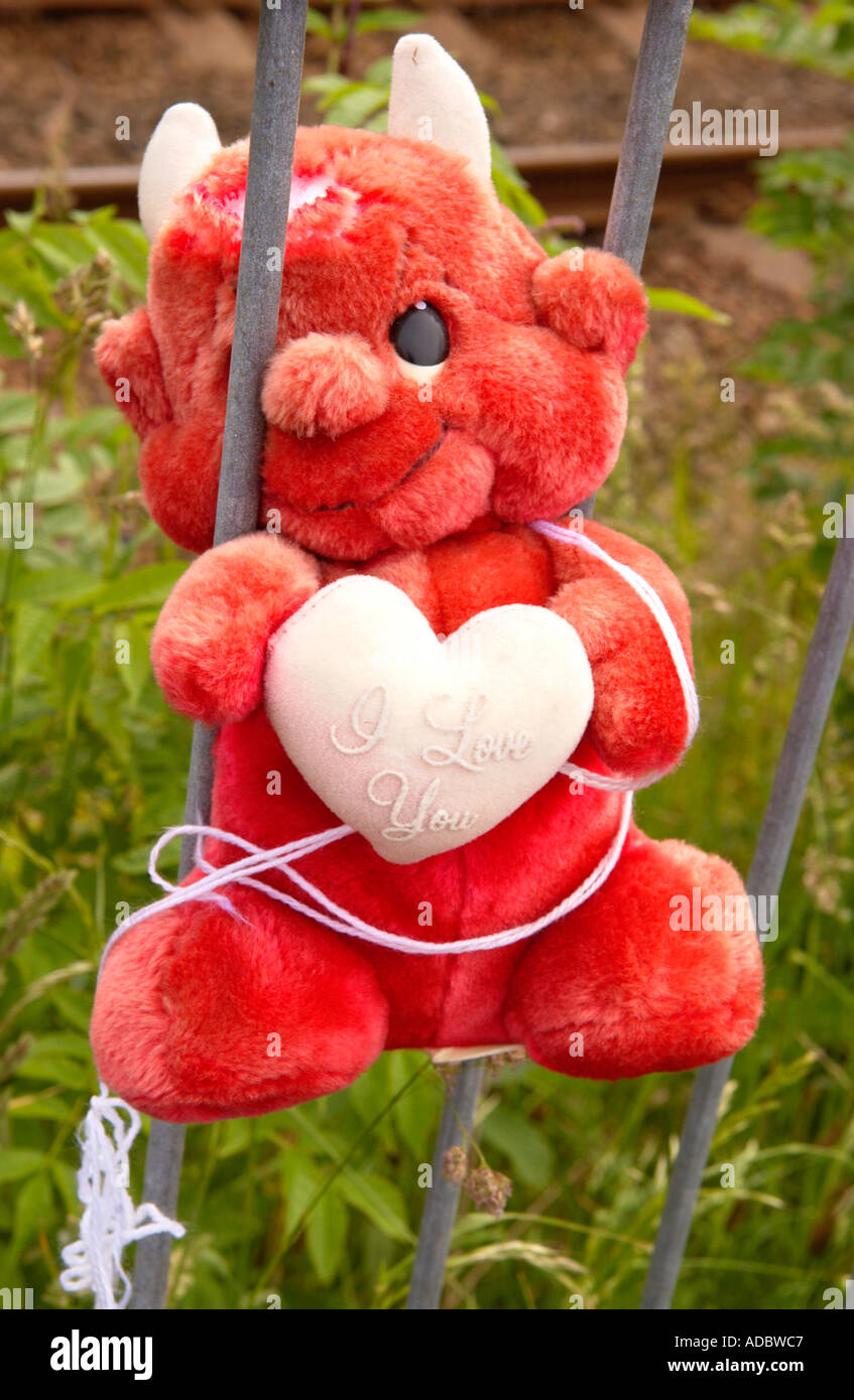 Red Devil soft toy wedged in railings next to the railway line at ...