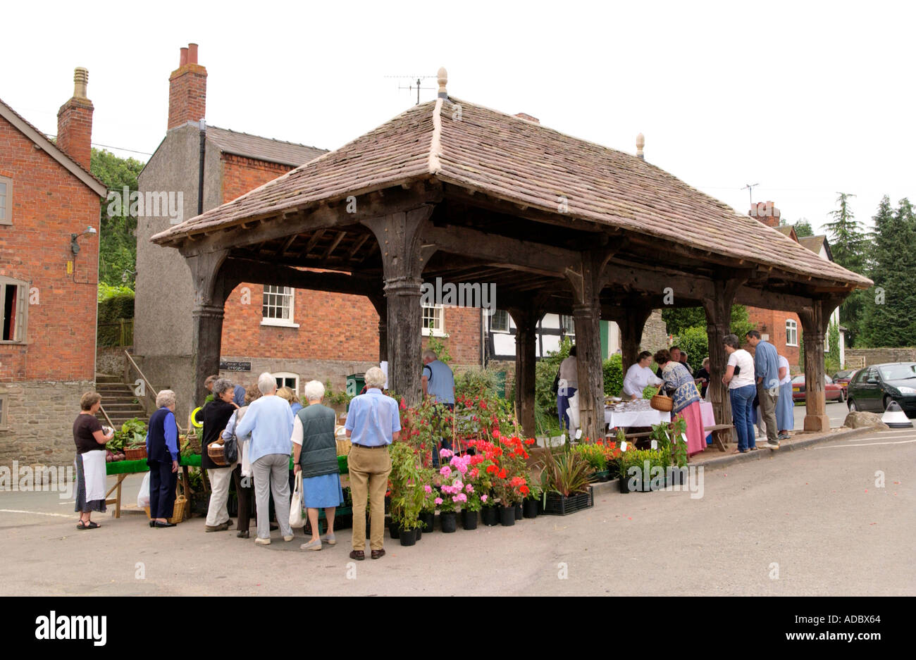 Farmers market held in 16th century open sided market hall in village ...
