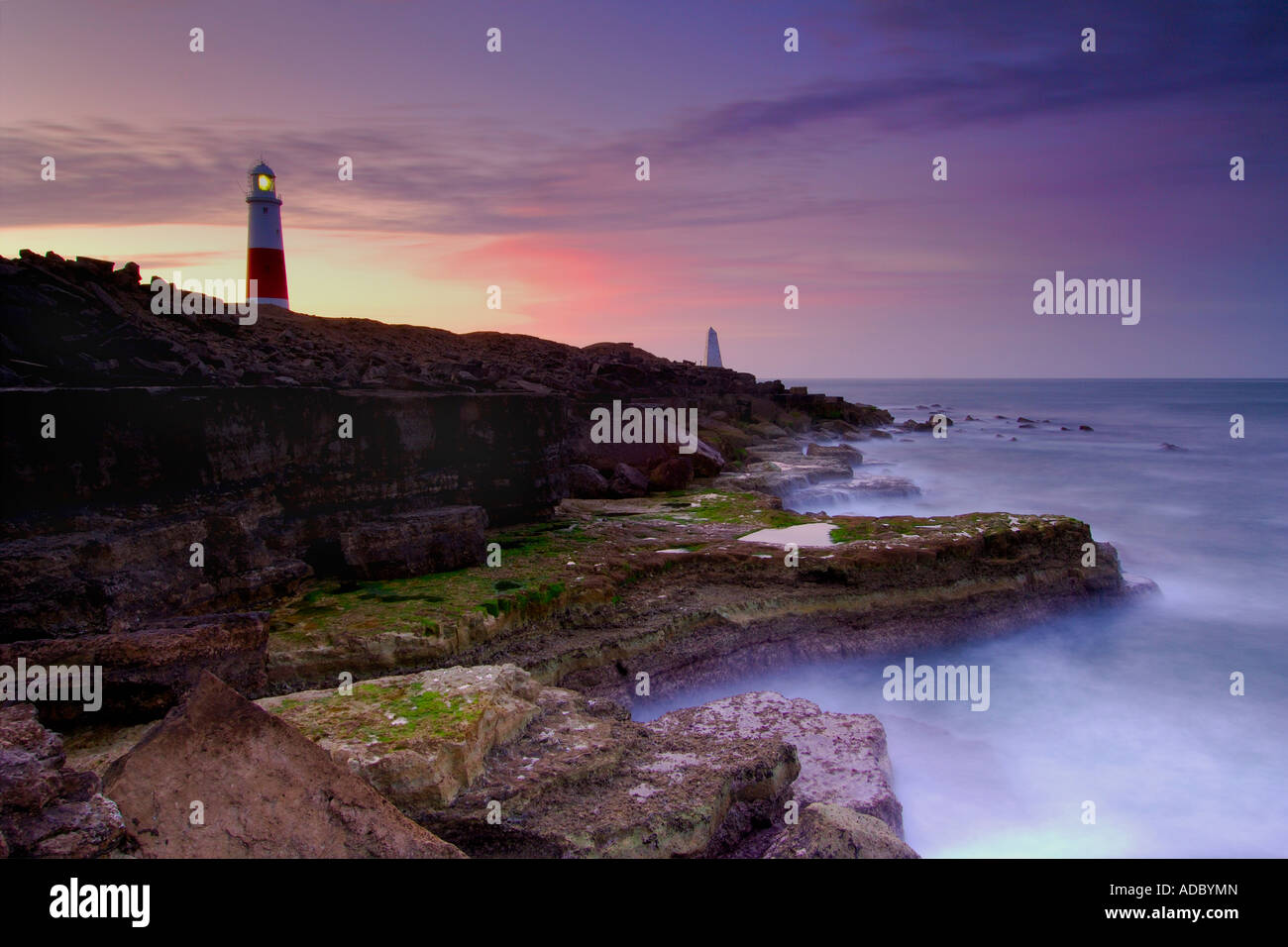 Portland Bill lighthouse just before dawn with the sea at low tide ...