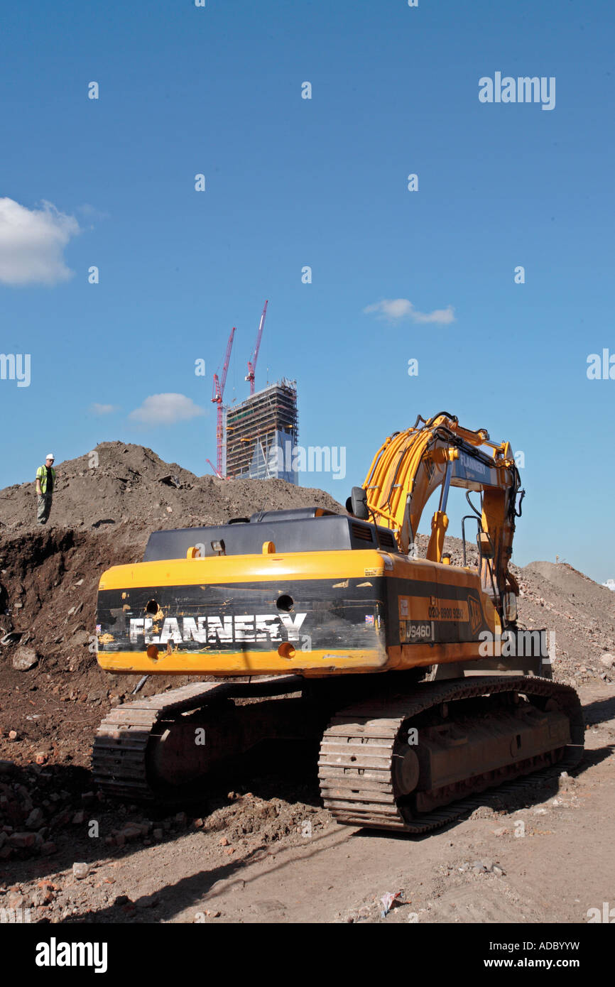 a bulldozer with a new skyscraper being built in the city of london in ...
